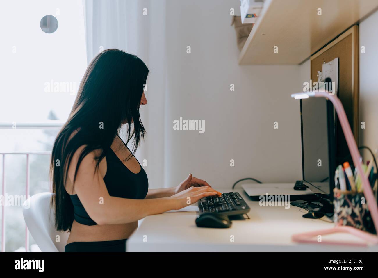 Woman sitting desk typing keyboard hi-res stock photography and images ...