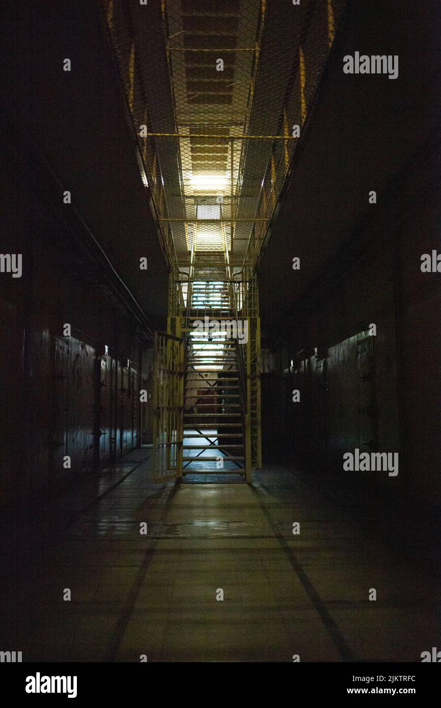 A dark corridor and metal stairs in an old prison Stock Photo - Alamy