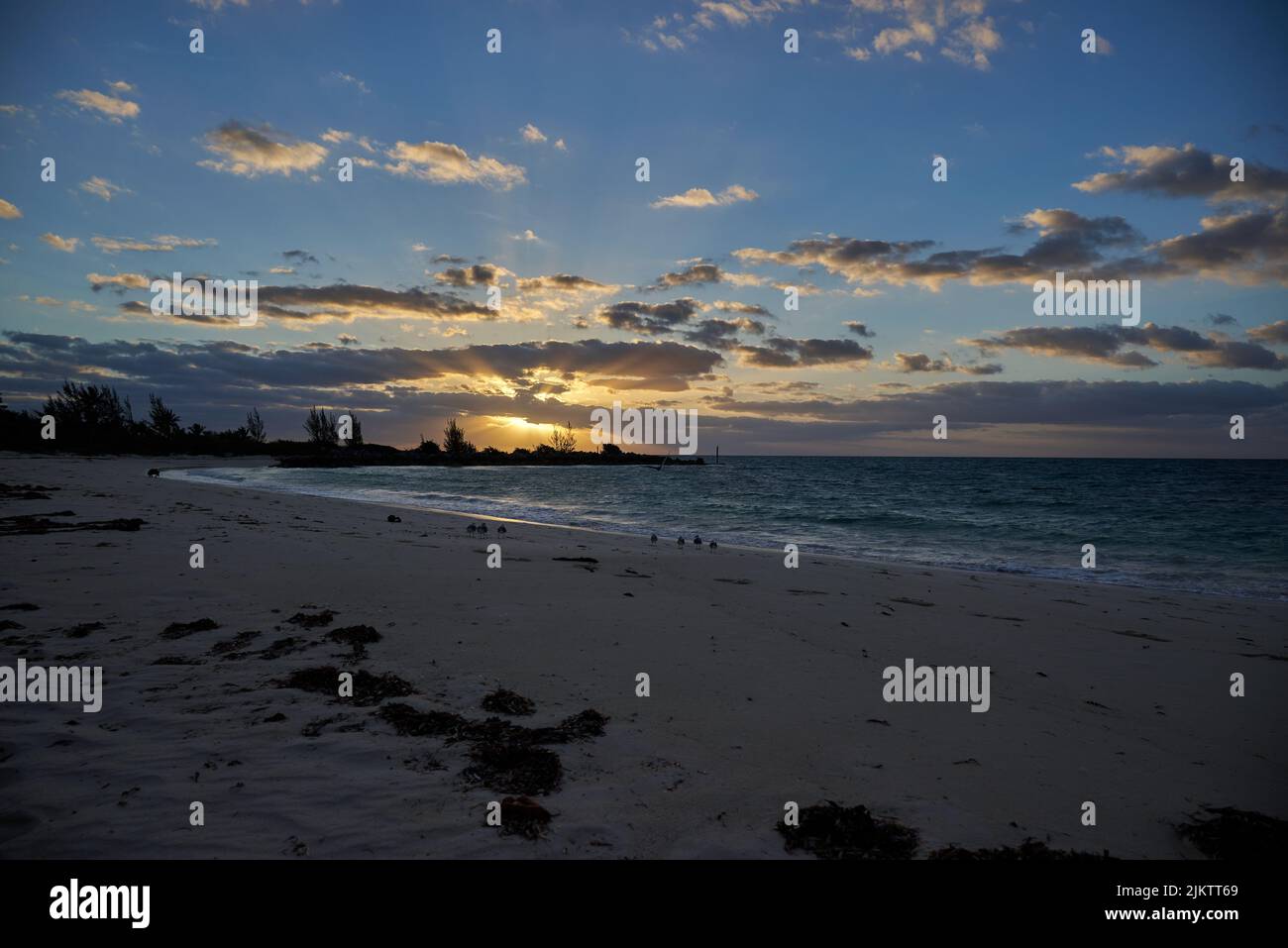 A scenic shot of sun rays shining through the clouds at sunset at the ...