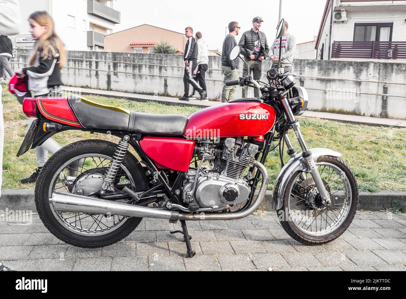 A scenic shot of a vintage Suzuki GS red and black motorcycle from ...