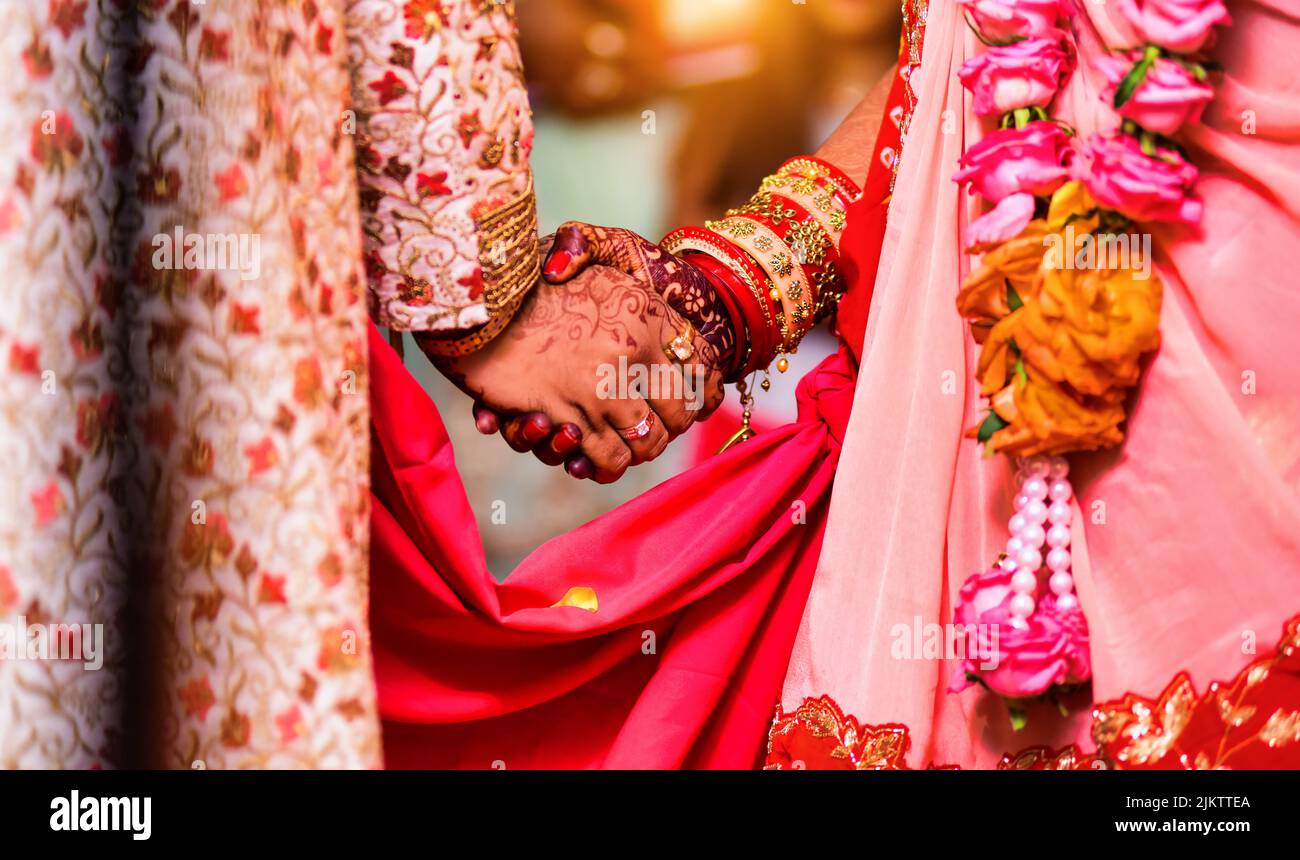 A Closeup of hands with henna tattoos during an Indian traditional ...