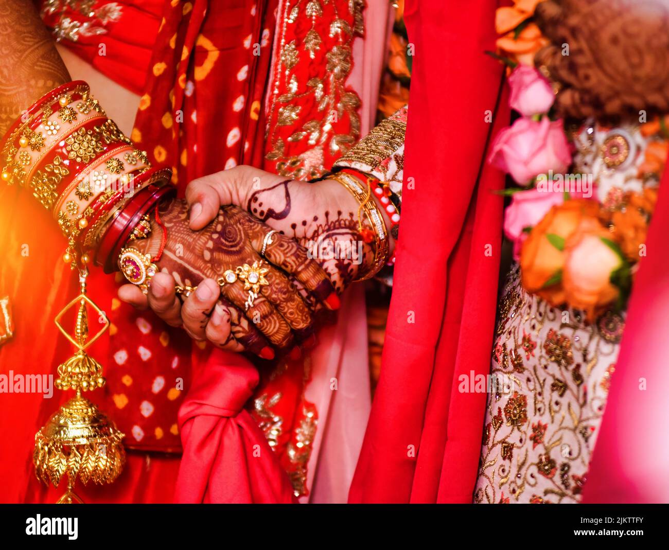 A Closeup of hands with henna tattoos during an Indian traditional ...