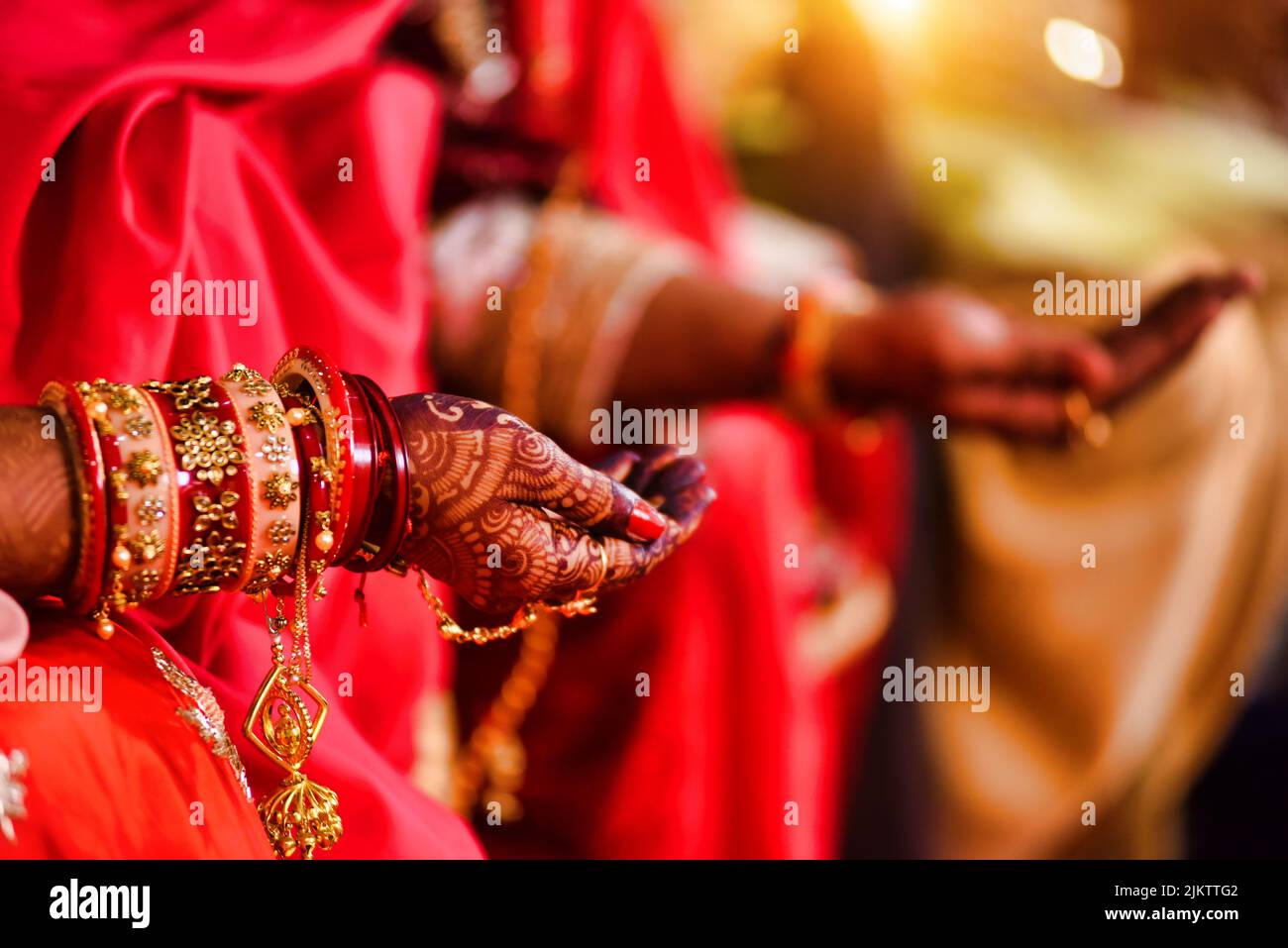 A Closeup of hands with henna tattoos during an Indian traditional ...