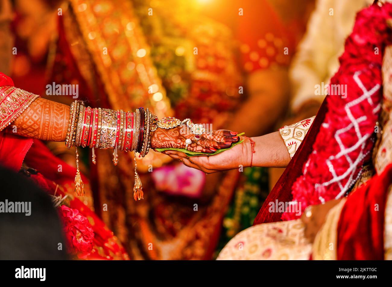 A Closeup of hands with henna tattoos during an Indian traditional ...