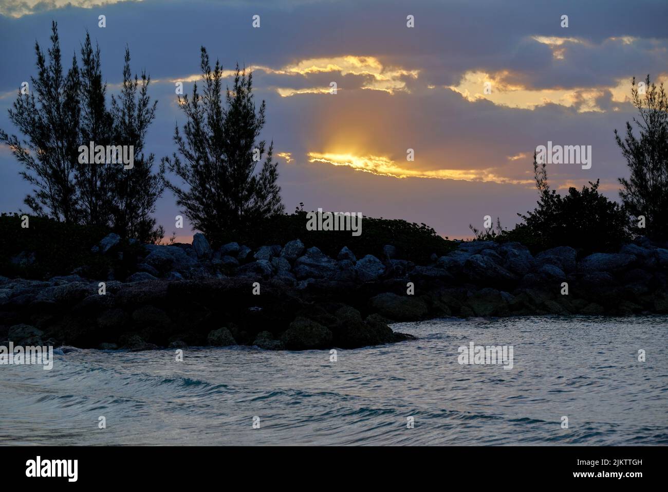 beautiful golden sun rays shining through the clouds at sunset Stock ...