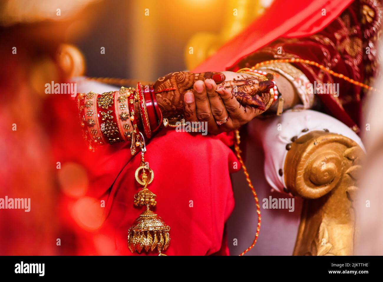 A Closeup of hands with henna tattoos during an Indian traditional ...