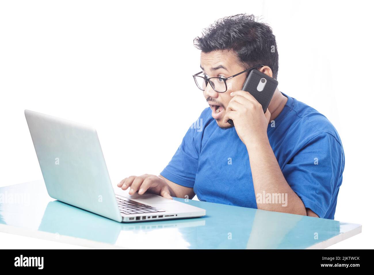 shocking man reading message on computer screen and talking over phone ...