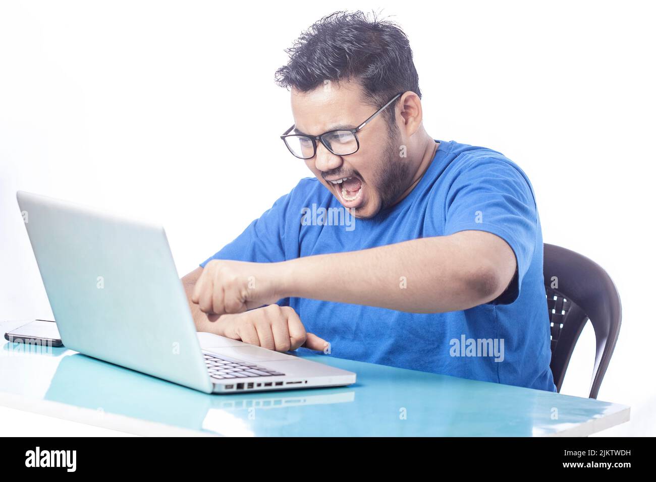 frustrated man screaming and punching his laptop screen Stock Photo - Alamy