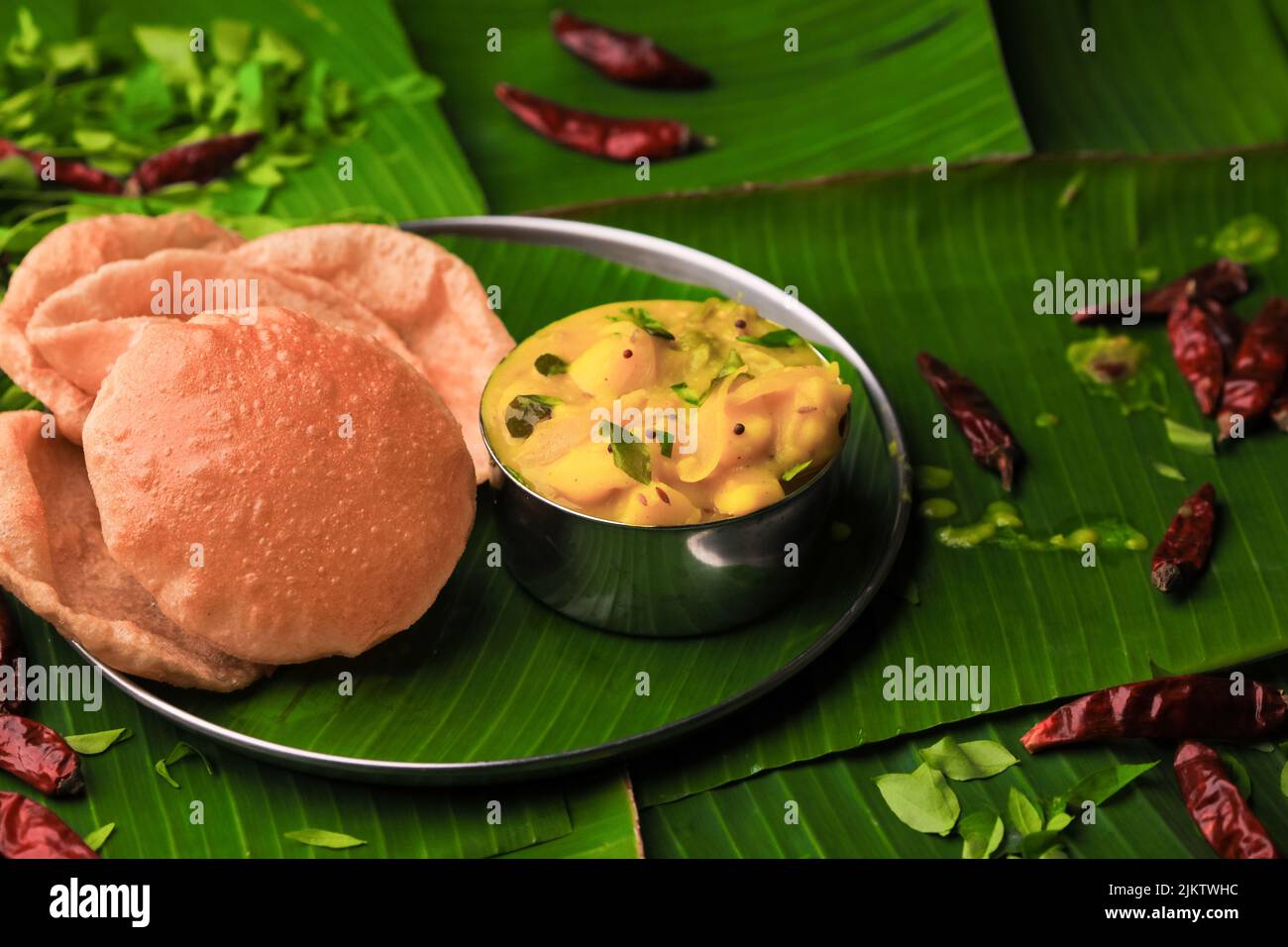 south indian famous breakfast poori or puri with potato curry served in ...