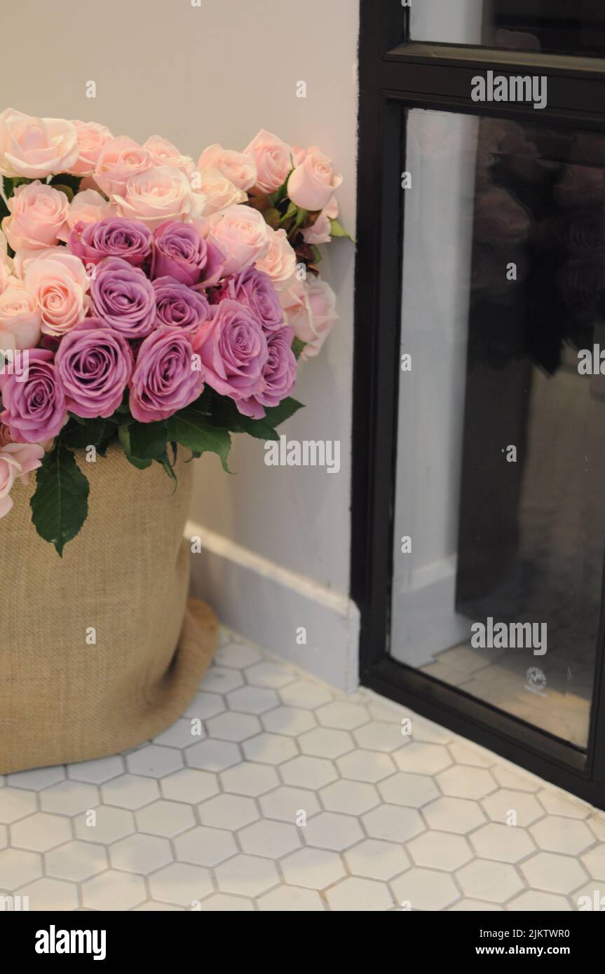 A vertical shot of a pink roses bouquet on the floor indoors Stock ...