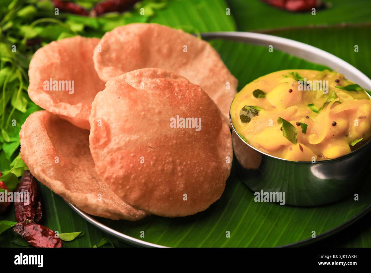 south indian famous breakfast poori or puri with potato curry served in ...