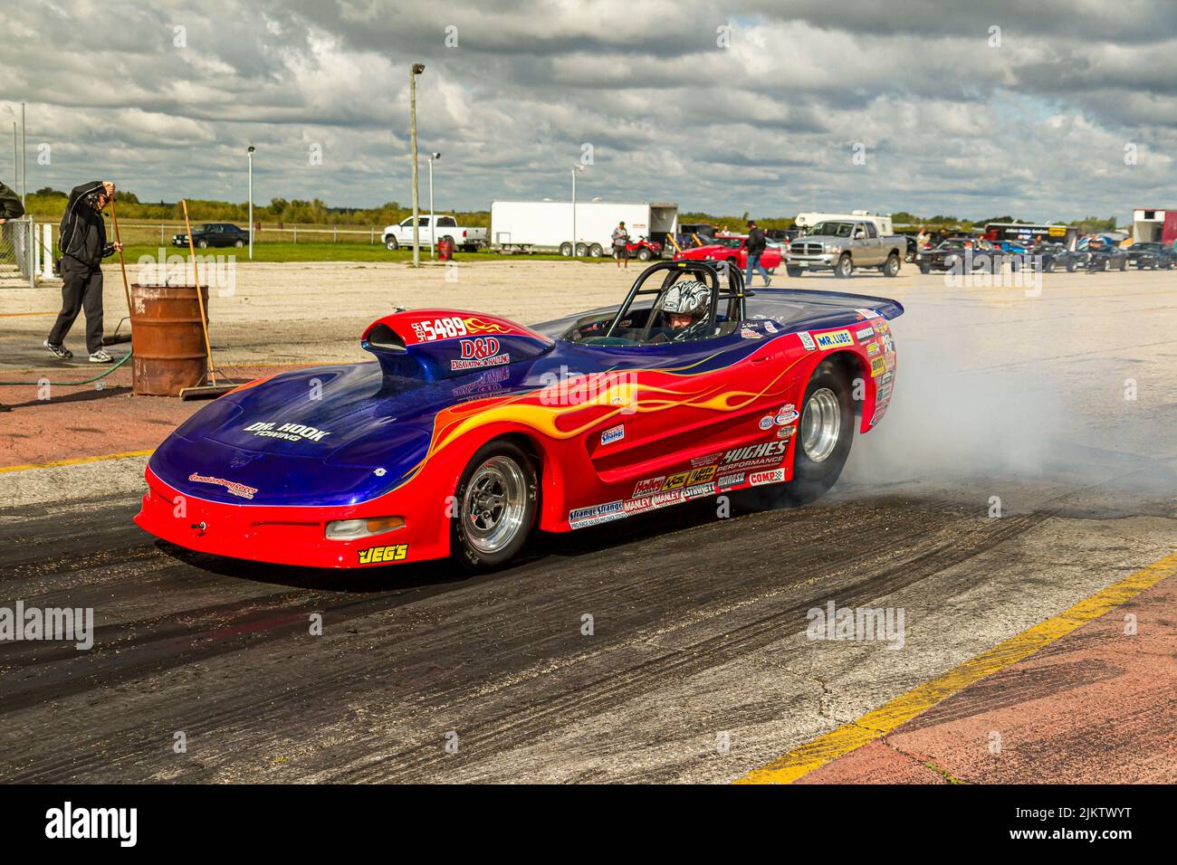 Funny car dragster doing a burnout with smoke before drag race. Burnout ...