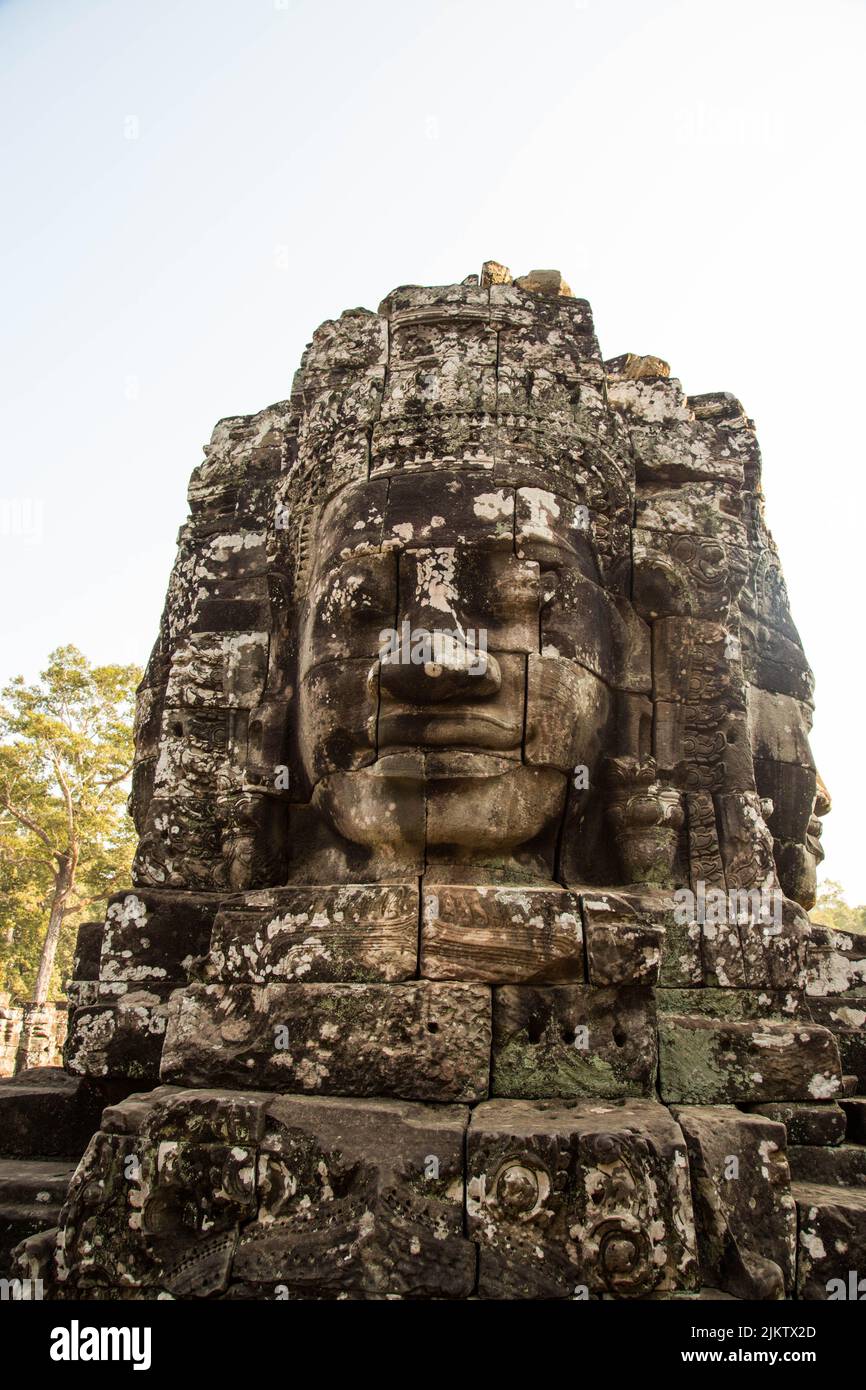 A vertical closeup shot of statue details on the Angkor Wat Temple in ...