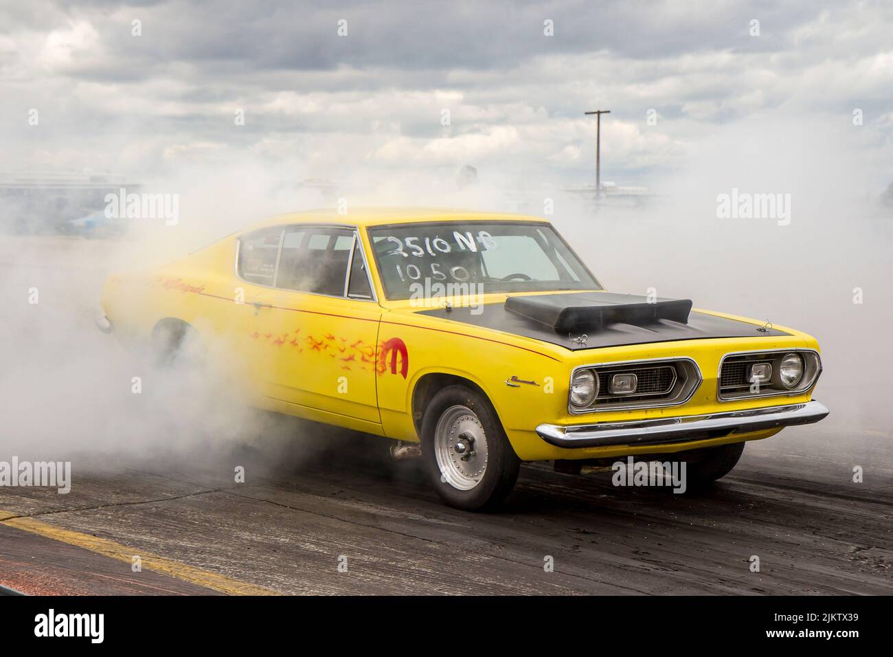 Burnout by a dragster with smoke before drag race. Burnout at the ...