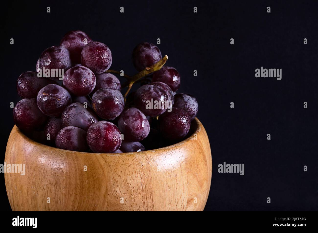 Organic and very sweet fresh grape on black background Stock Photo - Alamy