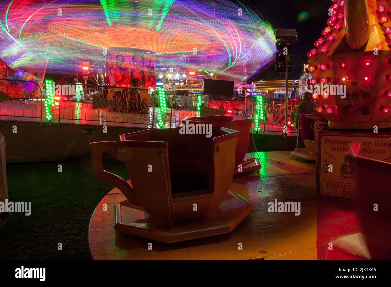 Light traces from the children's spinning teacups and 'Extreme' ride at ...