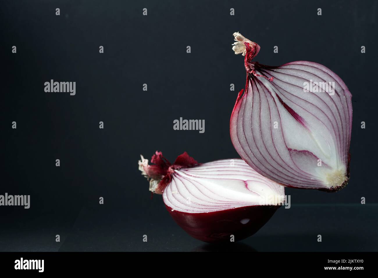 The Red onion and half slice on black background Stock Photo - Alamy