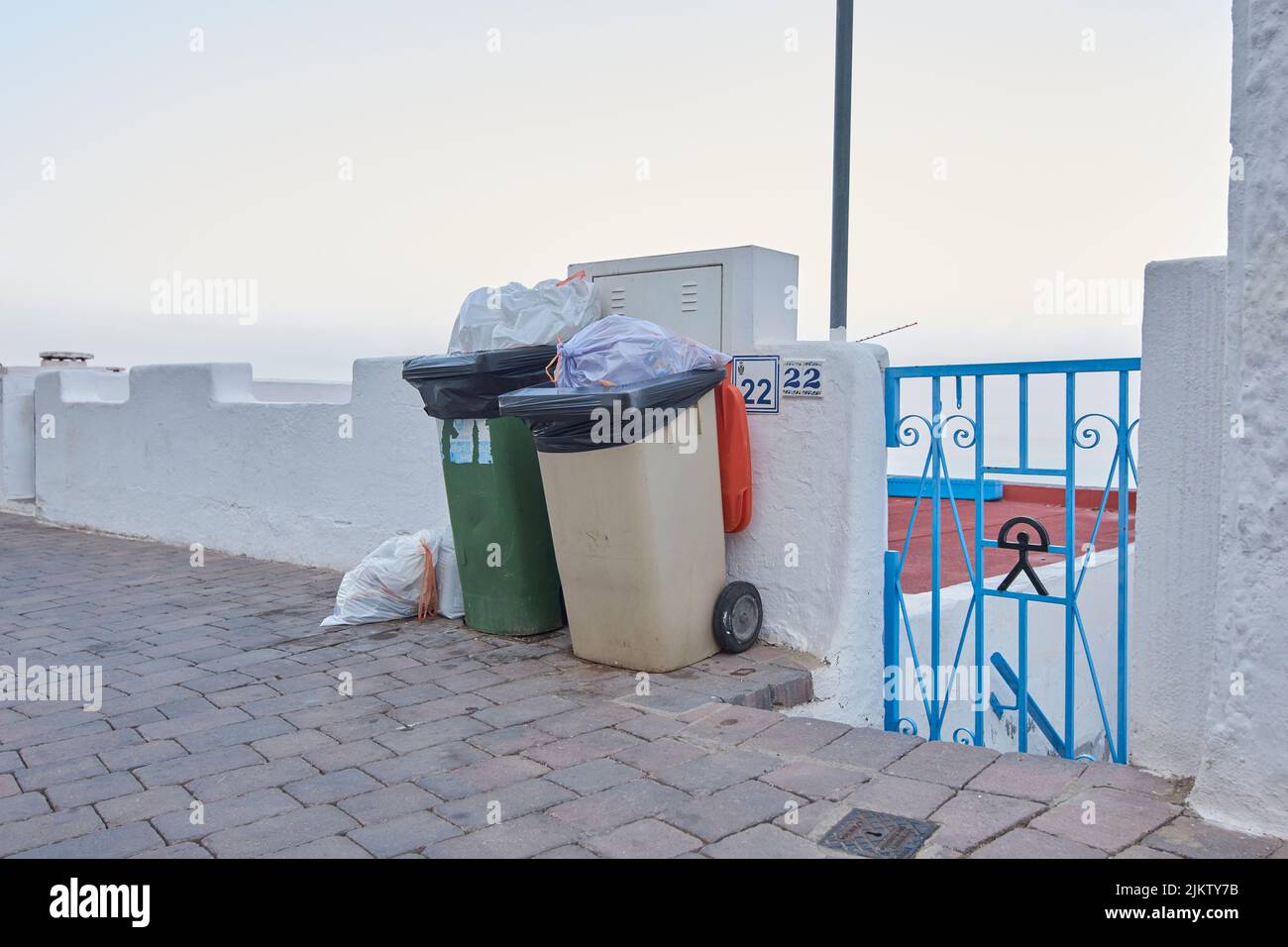 Full garbage cans on a street in Mojacar, Spain Stock Photo - Alamy