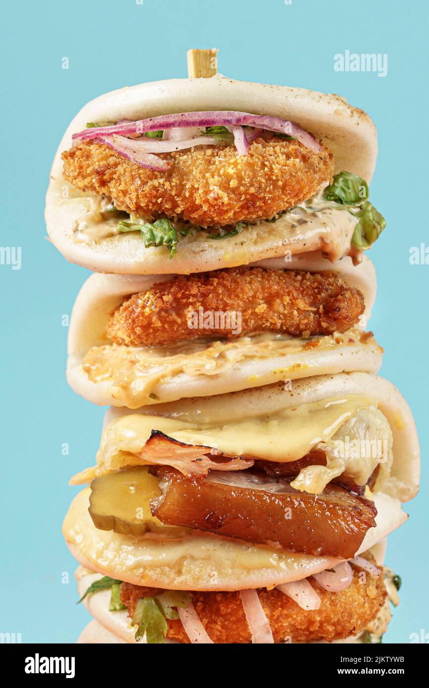 A Different Bao Buns filled with Fish, Meat, Pork on a blue background ...