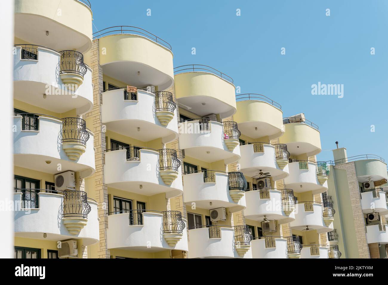 Facade of a sunlit apartment building in Alanya, Turkey Stock Photo - Alamy