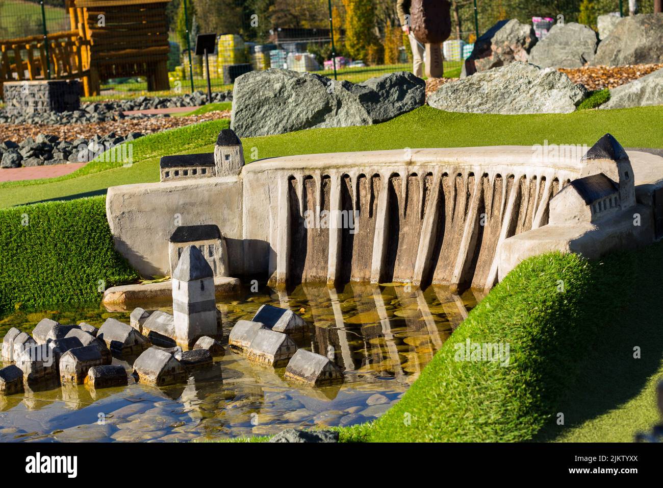 A small dam in a green park with a small lake next to it Stock Photo ...