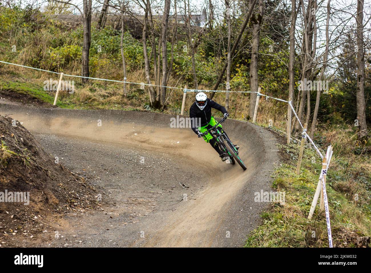 A biking race on a rural line between green hills and some trees Stock ...