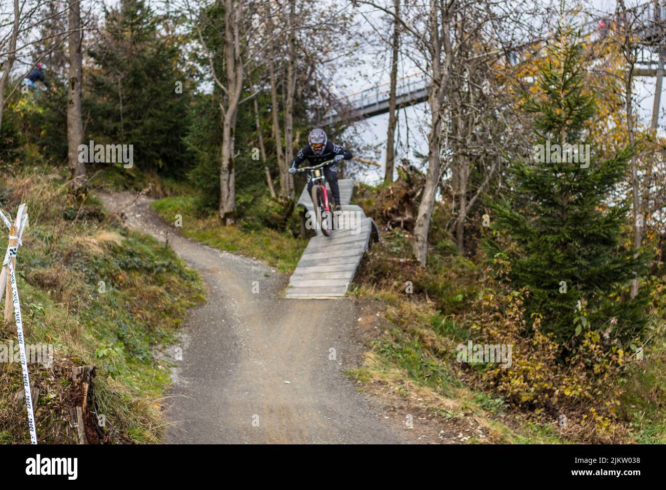 A biking race on a rural line between green hills and some trees Stock ...