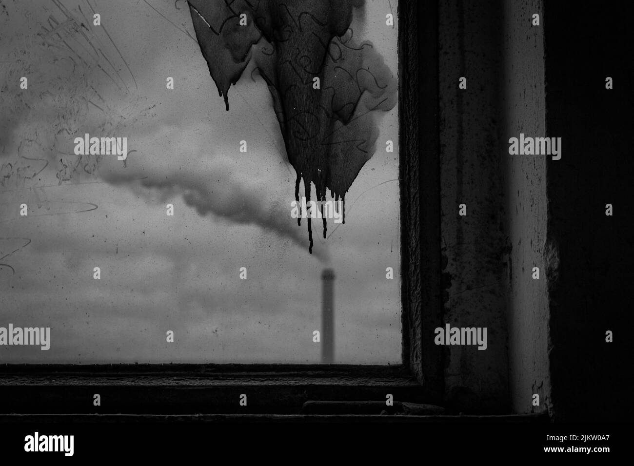 A grayscale window glass with a watercolor stain and a power plant ...