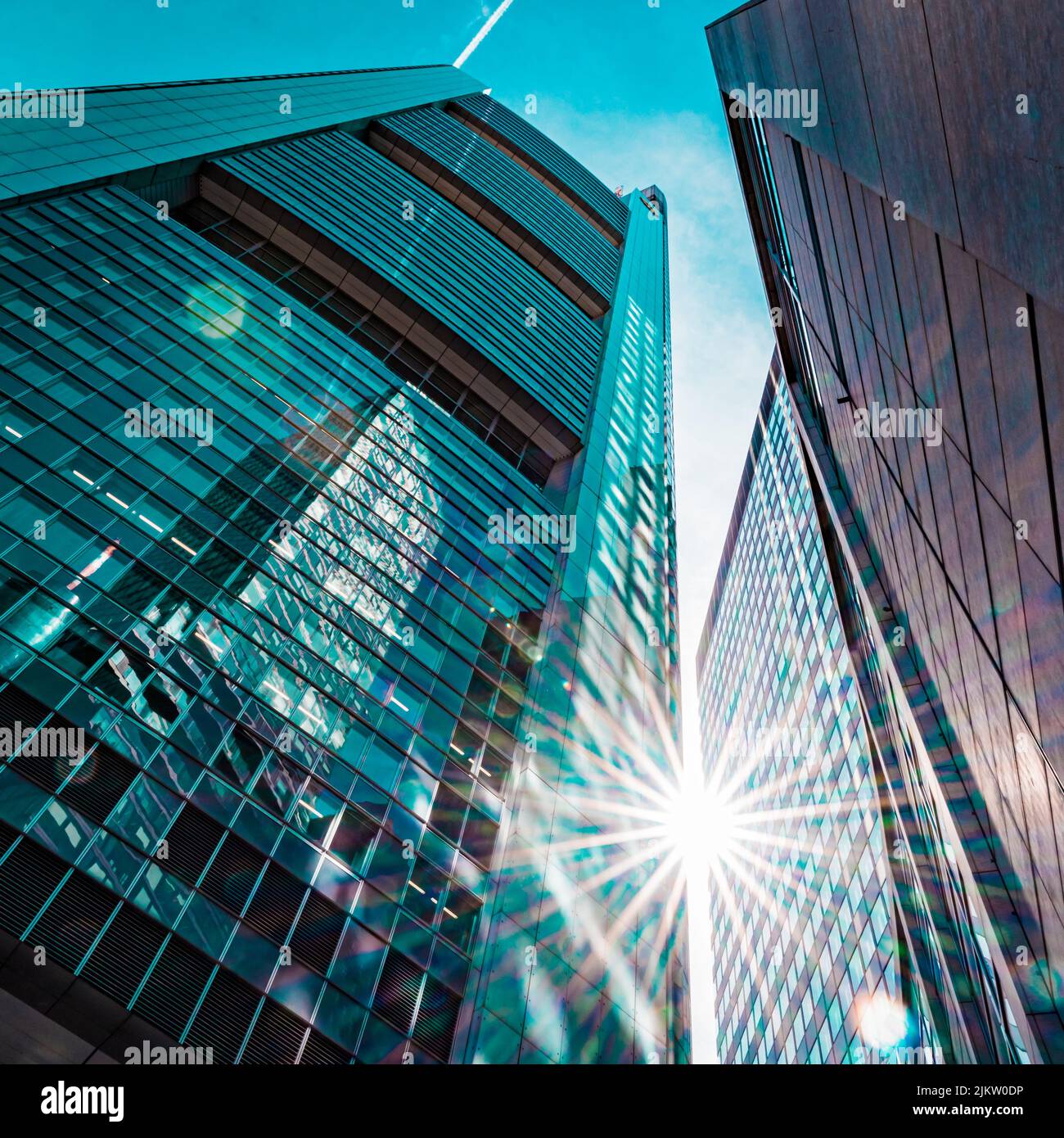 A vertical low angle view of tall skyscrapers with glass windows and ...