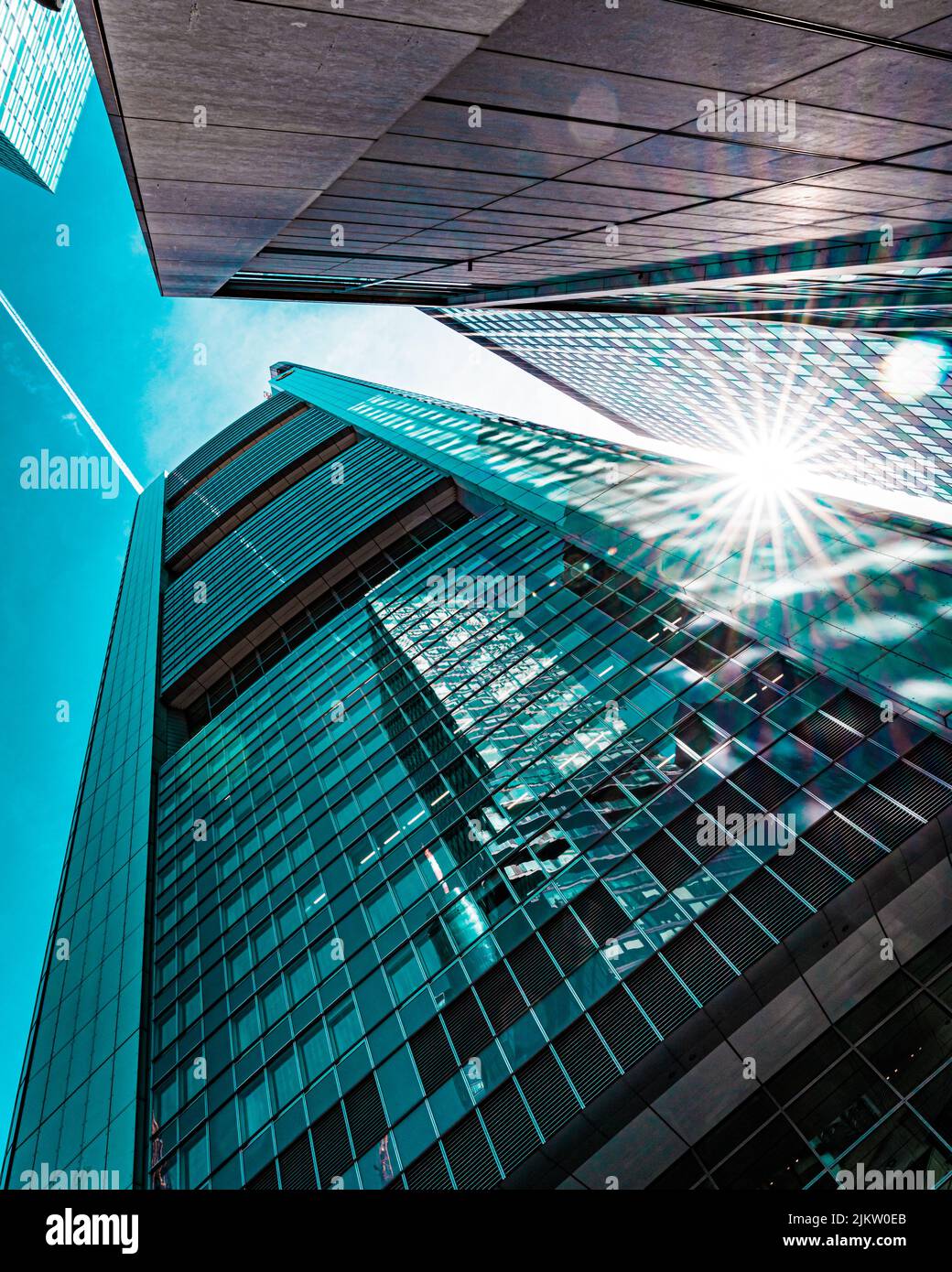 A vertical low angle shot of tall skyscrapers with glass windows and ...