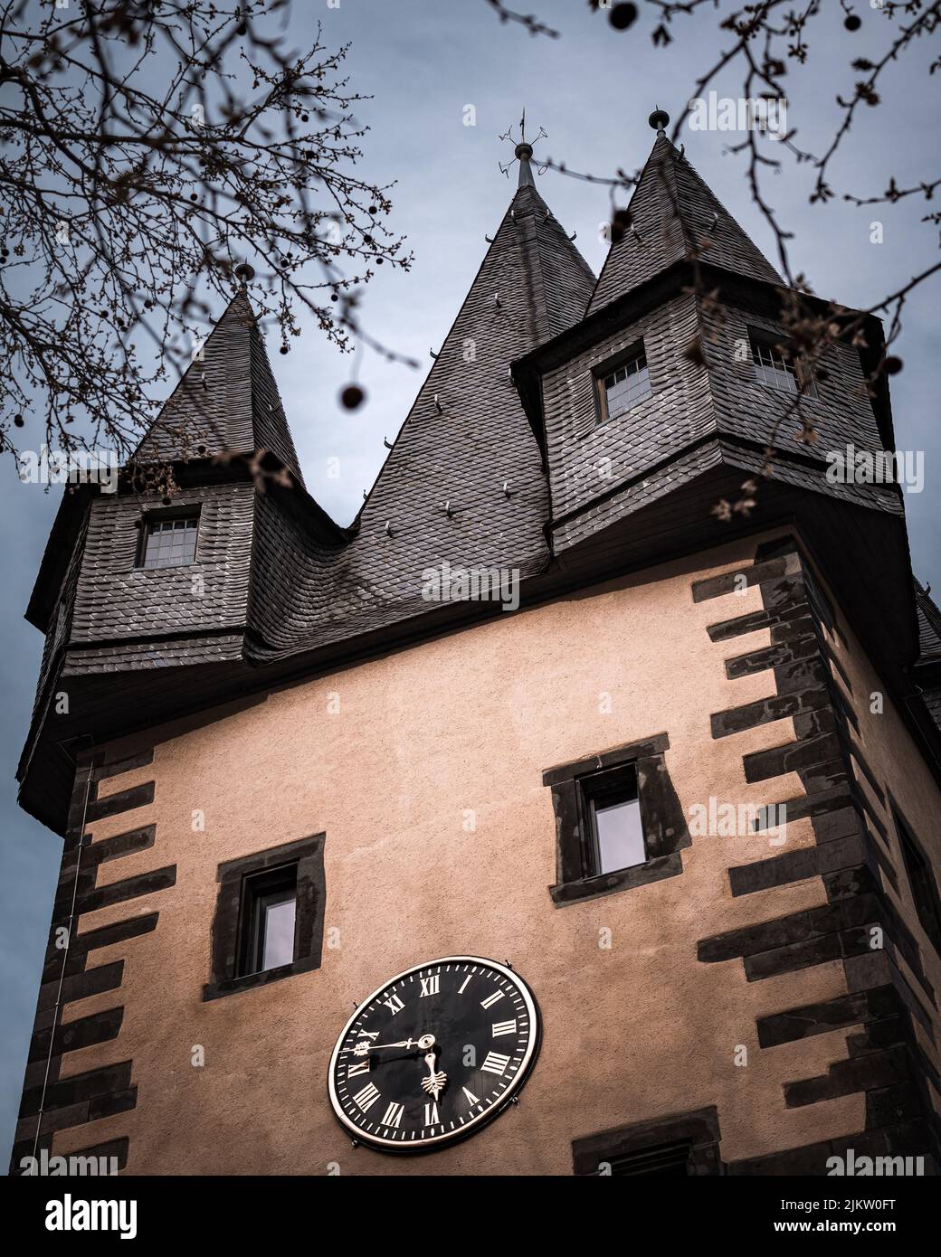 A vertical shot of a gothic castle with a clock in Frankfurt, Germany ...