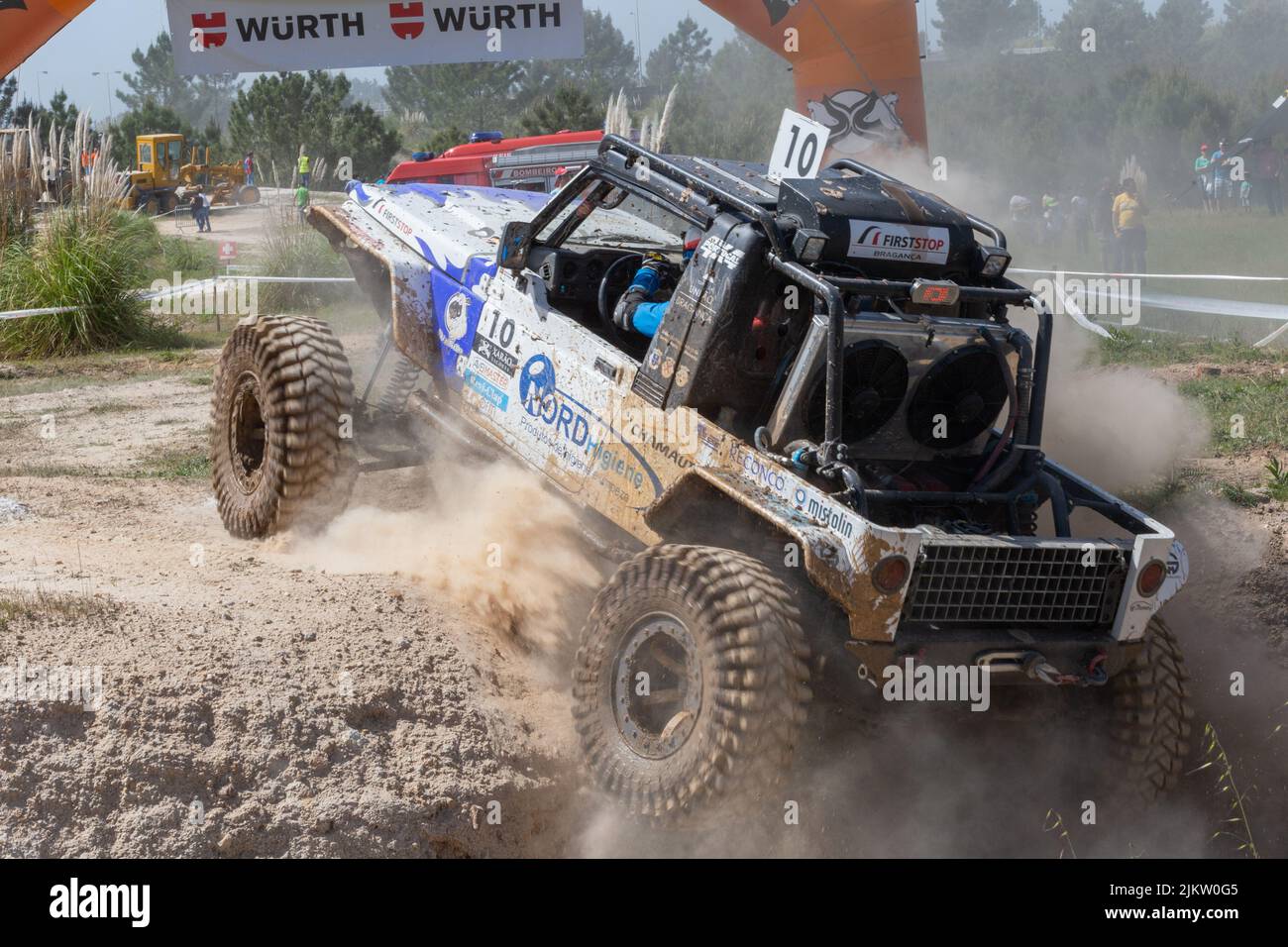 An off-road racing car covered with mud during National All Terrain ...