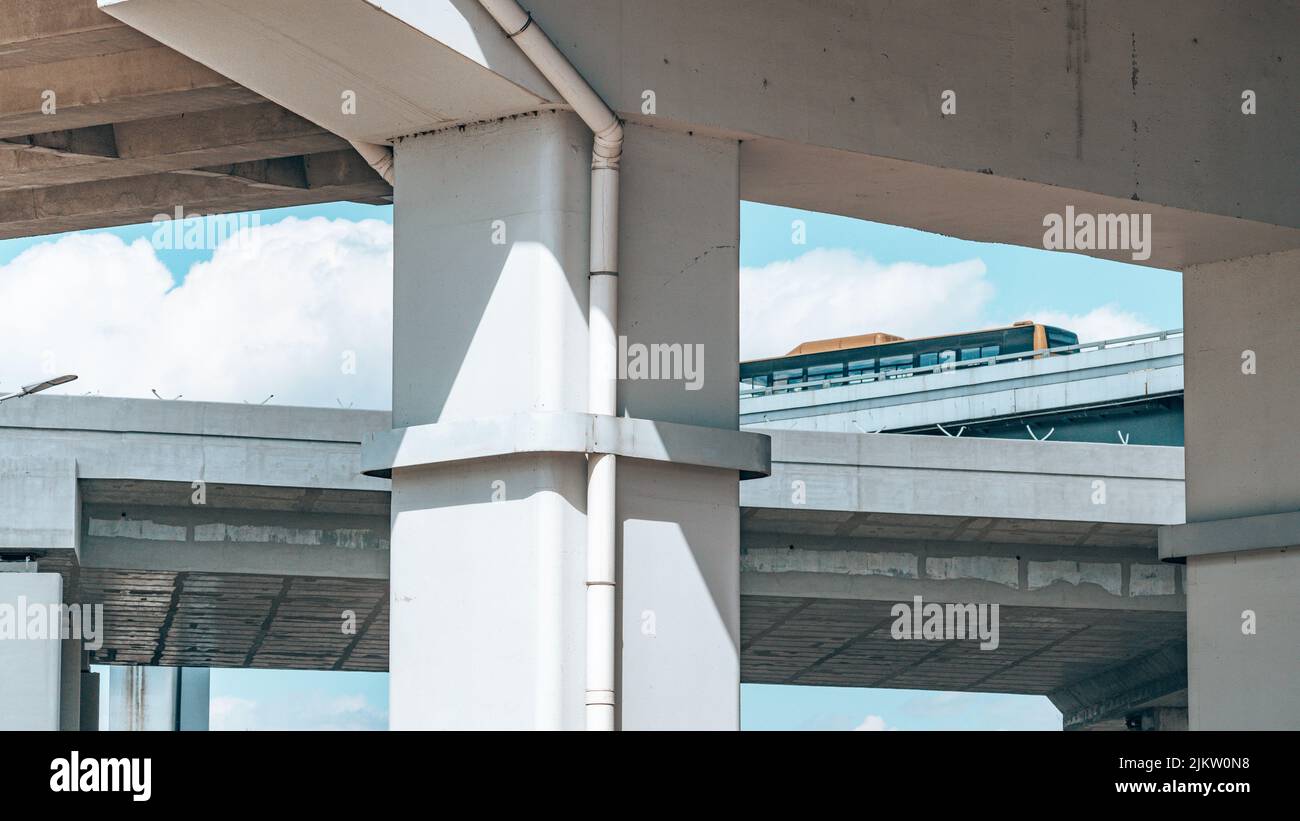 The concrete column with a drain under a bridge Stock Photo - Alamy