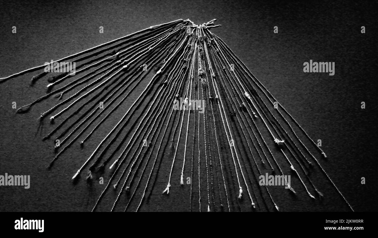 A top view grayscale shot of the knots of the Inca knot and threads at ...
