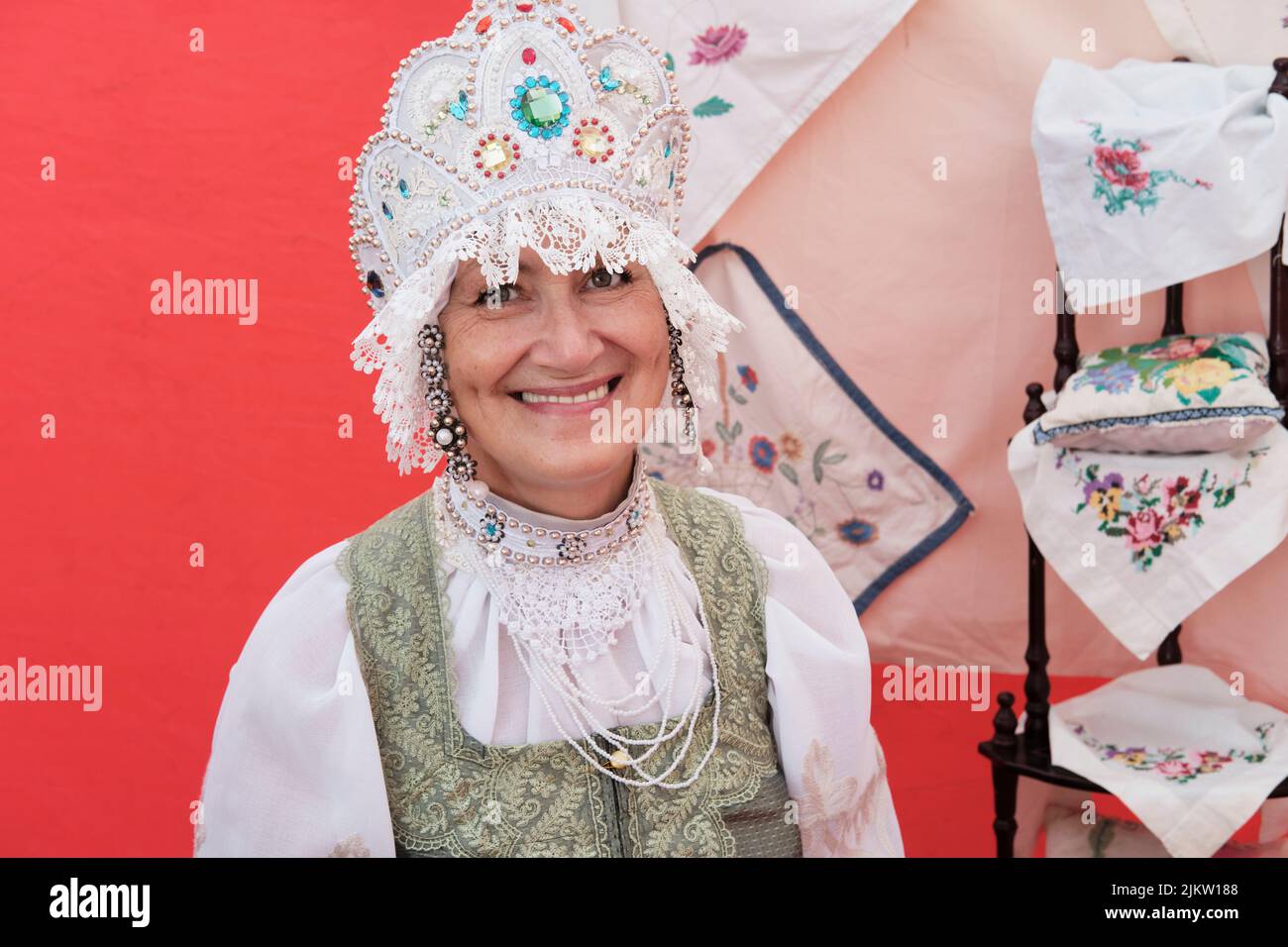 Portrait of smiling senior woman in stylized ancient Russian headdress ...