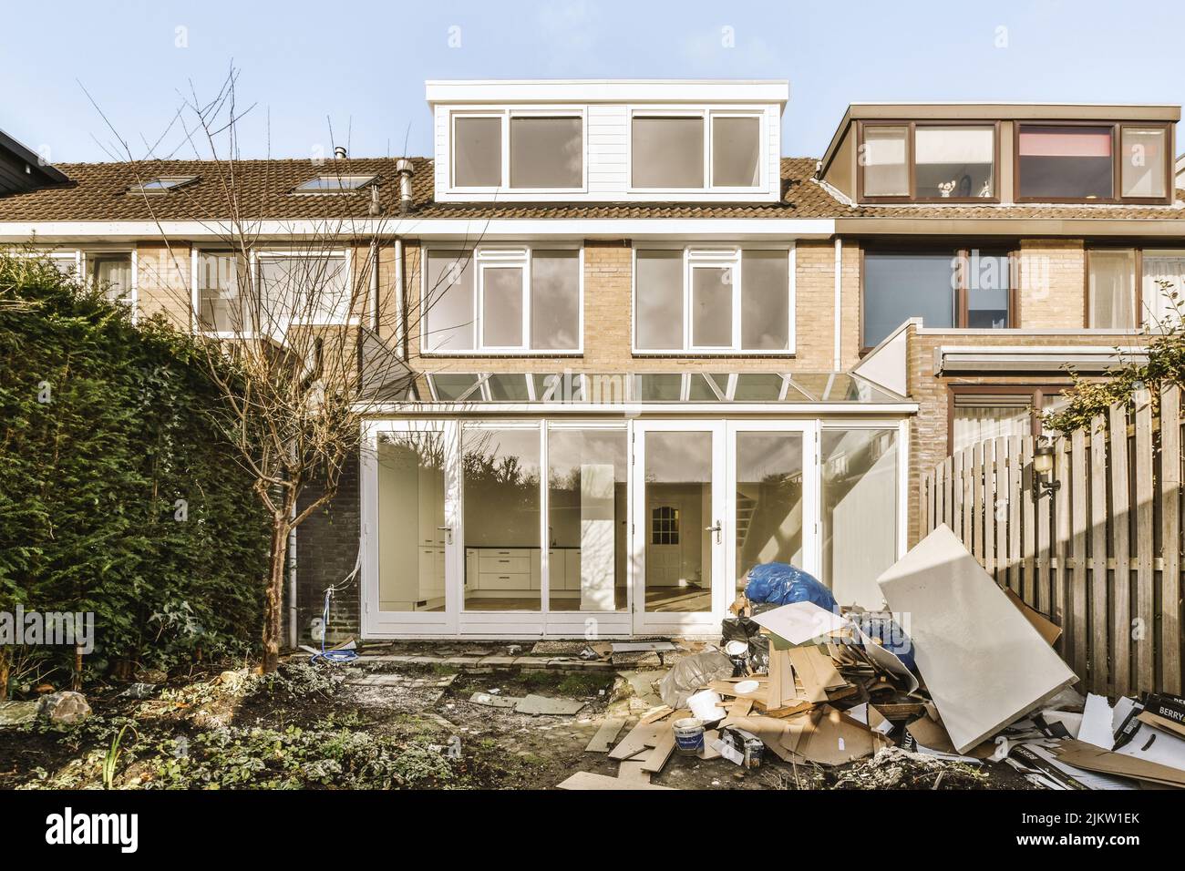Neat paved patio with wooden fence Stock Photo - Alamy