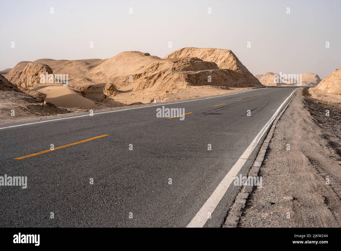 A highway surrounded by rocks in Yardang Stock Photo - Alamy