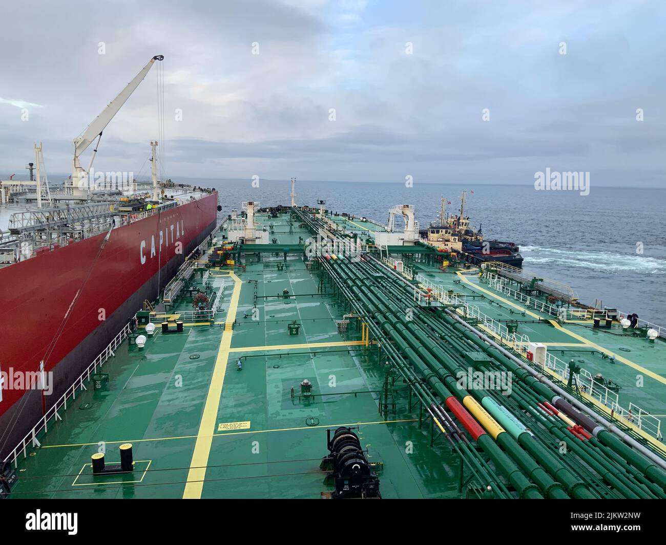 A pilot boat approaching to a big vessel in the sea Stock Photo - Alamy