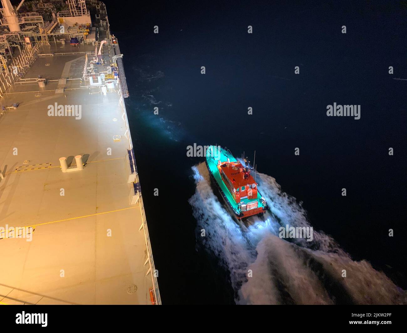 The pilotboat waiting to disembark the pilot from a bulkcarrier. Off ...