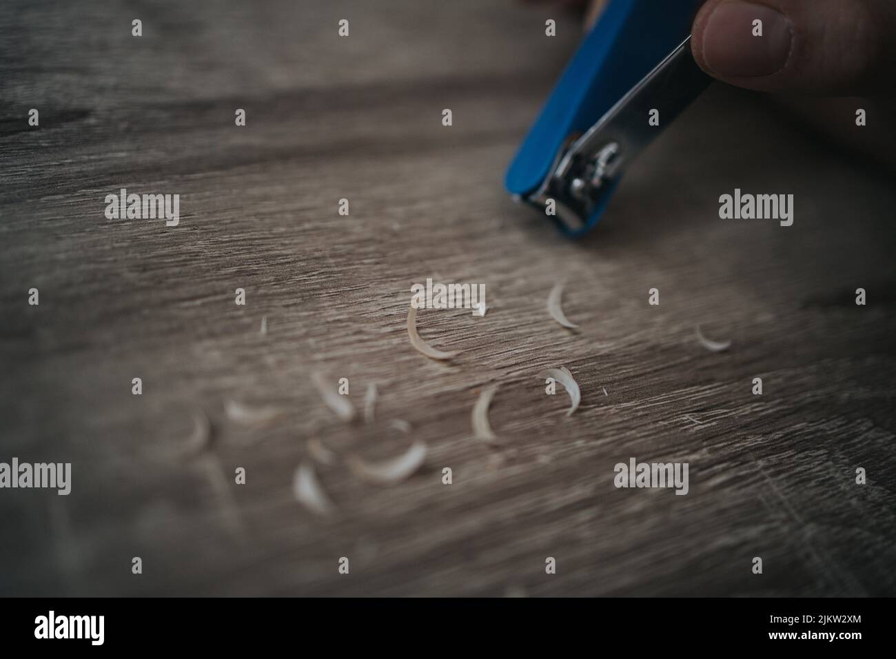 A Closeup shot of a nail clippers and the clipped parts of nails Stock ...