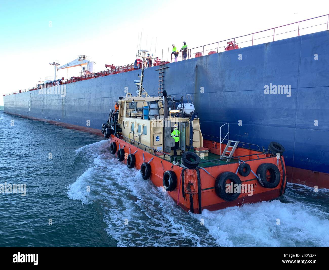 A pilot boat approaching to a big vessel in the sea Stock Photo - Alamy