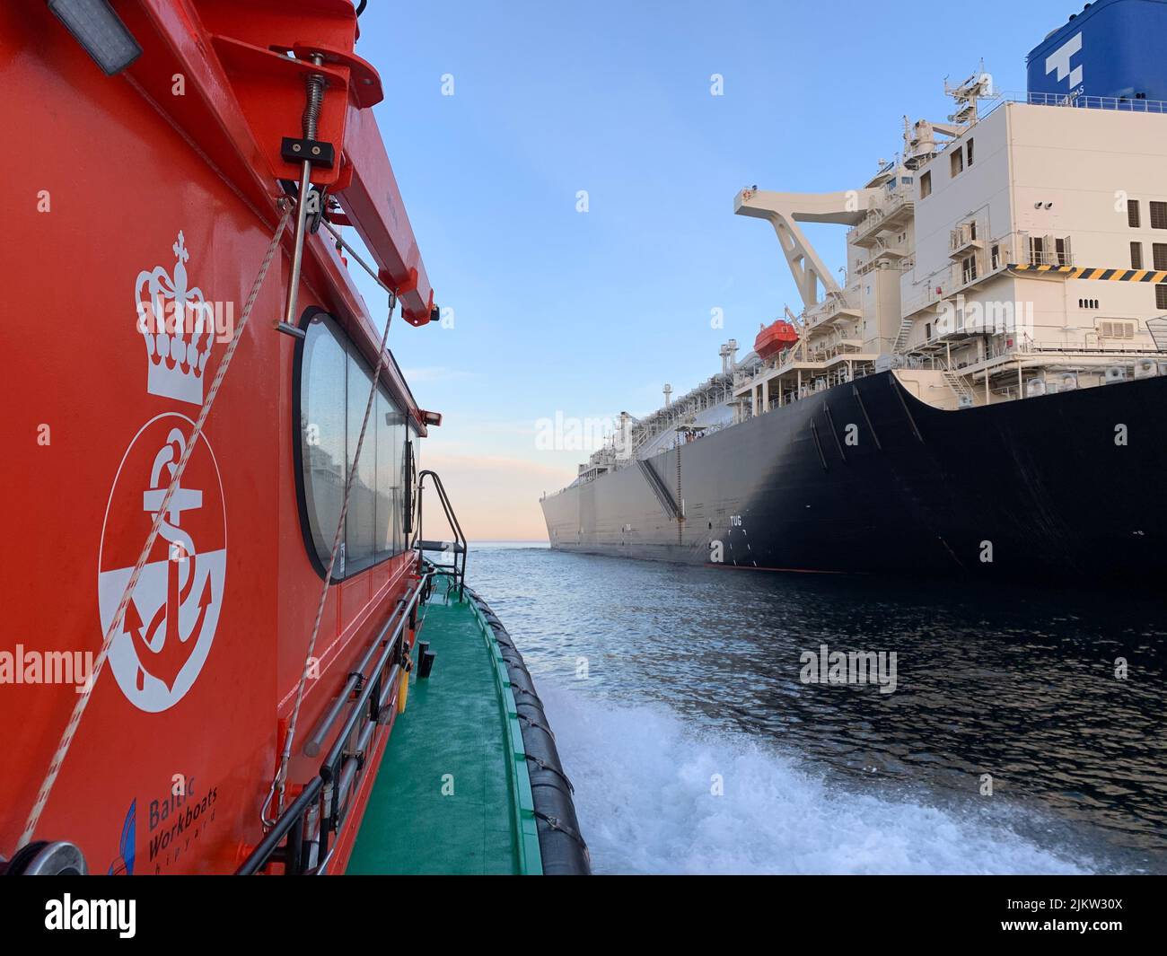 A pilot boat approaching to a big vessel in the sea Stock Photo - Alamy