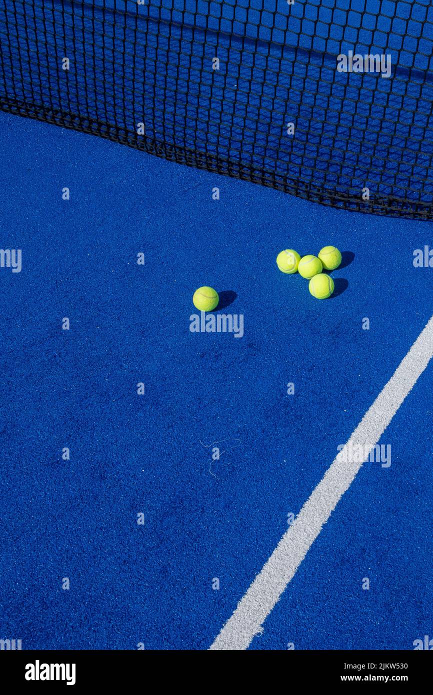 paddle tennis balls by the net on a blue paddle tennis court Stock ...