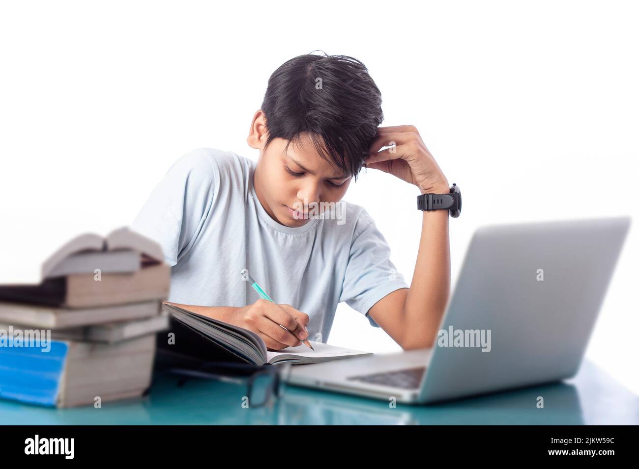 student taking online class with books and laptop on a desk in isolated ...