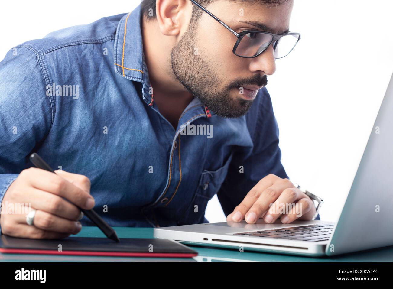 young digital artist using stylus pen and digital tablet for drawing ...