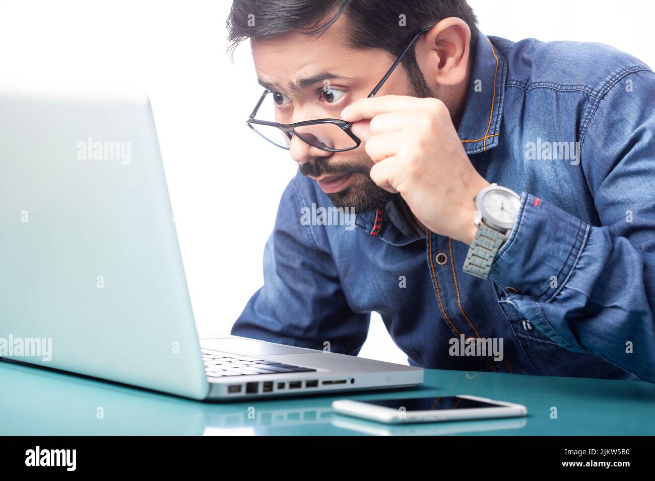 Indian man looking over eyeglasses hi-res stock photography and images ...