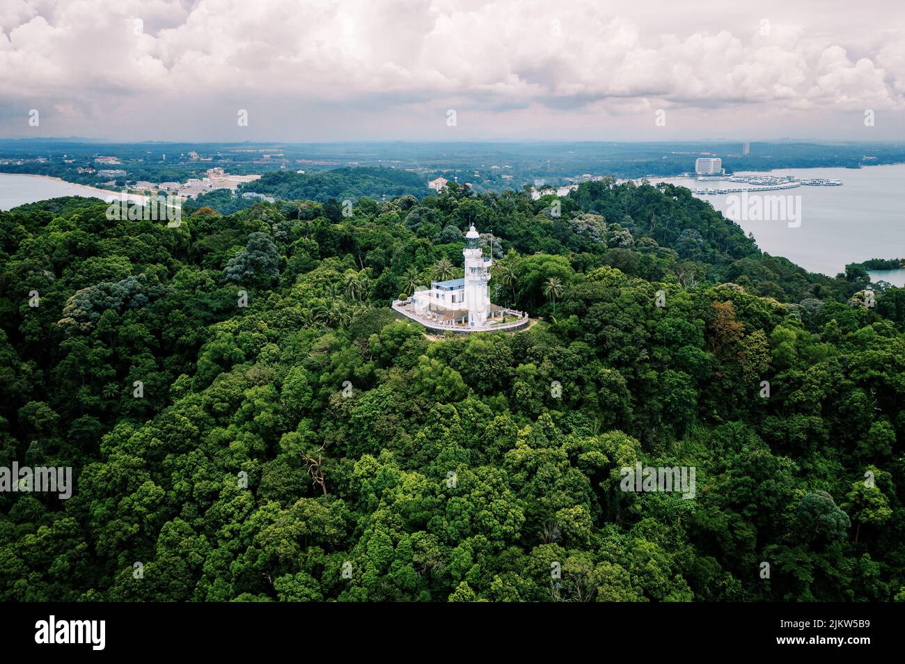A bird's eye view of a lighthouse on top of a mountain covered with ...