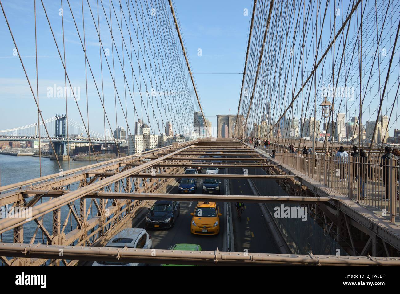 A high angle of the cars driving on the Brooklyn Bridge in New York ...