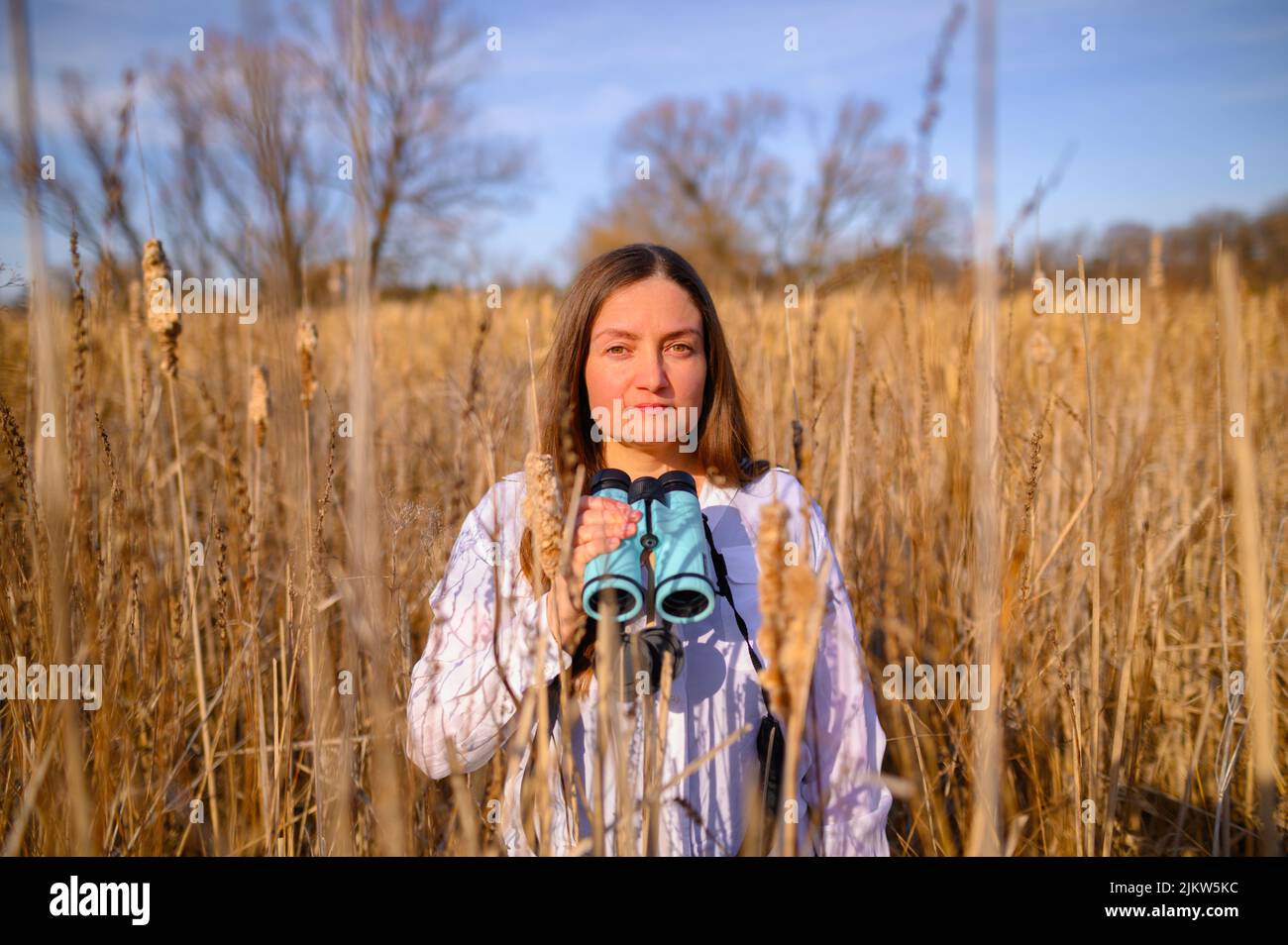 Woman looking at the camera straight on, with a neutral expression ...