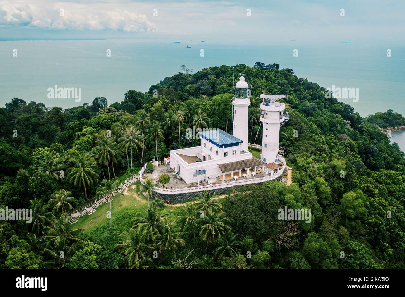 A bird's eye view of a lighthouse on top of a mountain covered with ...